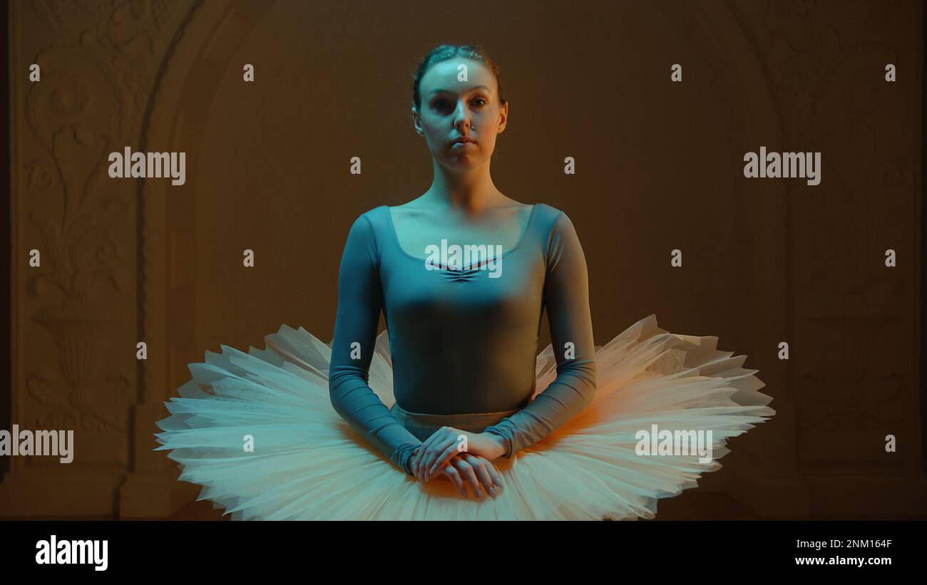 Cinematic shot of elegant ballerina in ballet tutu standing in opera ...