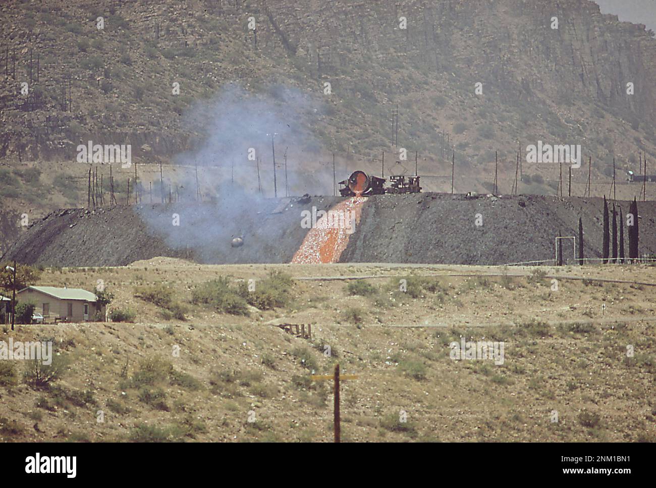1970s America: Slag pours from Phelps Dodge Corporation copper mine. In ...