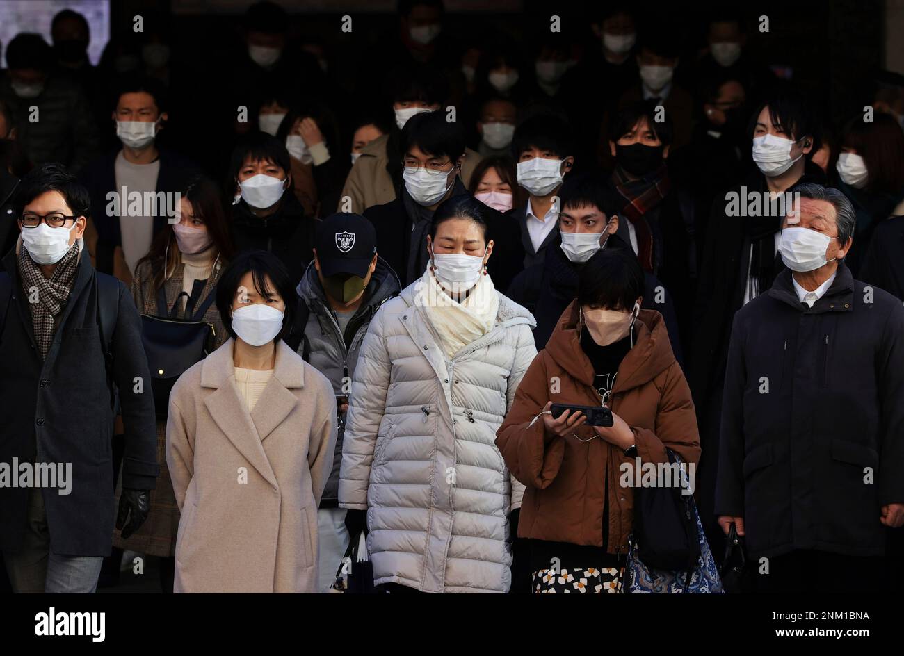 Commuters wearing masks are seen near Tokyo Station in Chiyoda Ward ...
