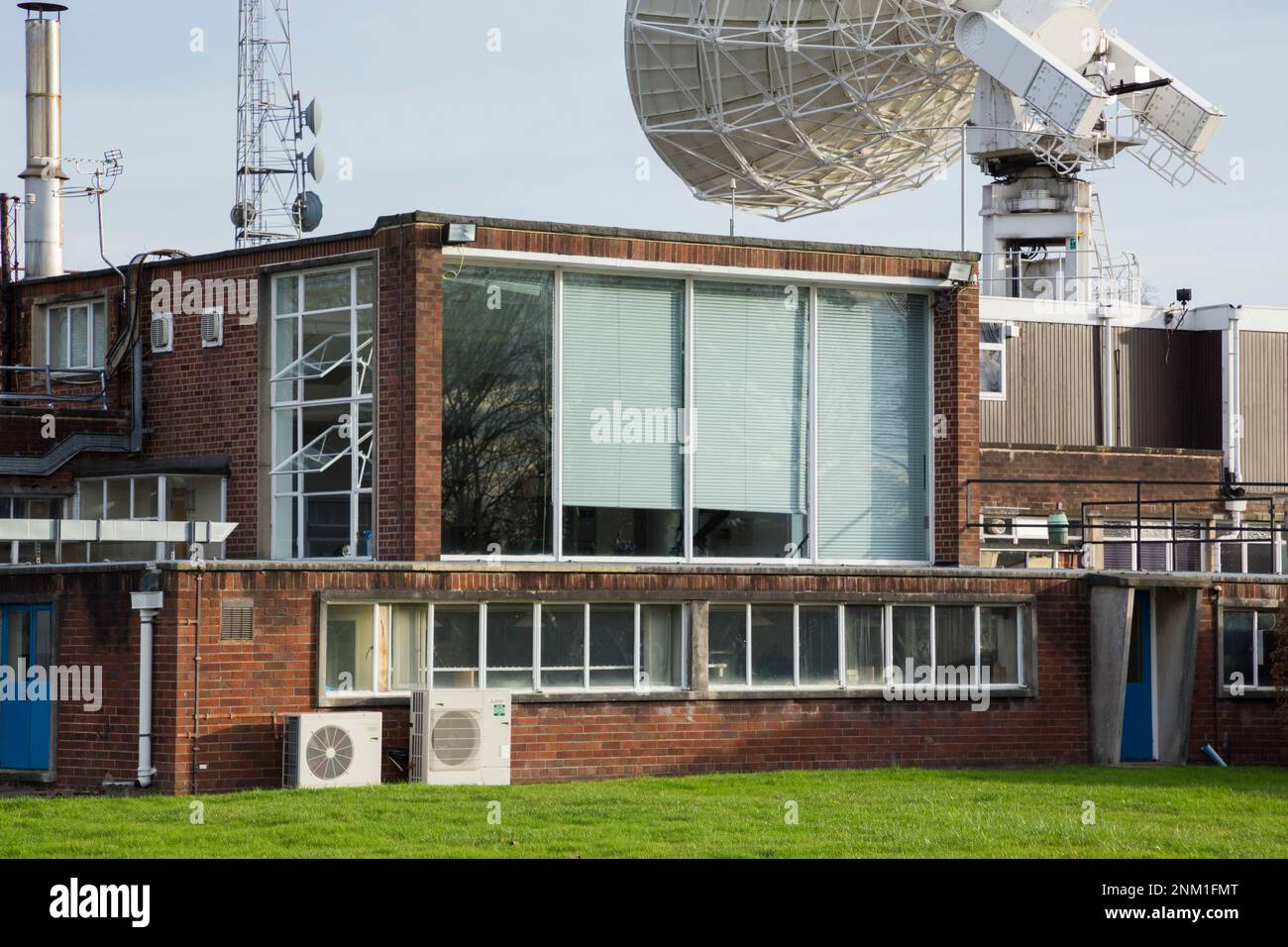 The control room (with the large windows protected by blinds) of the ...