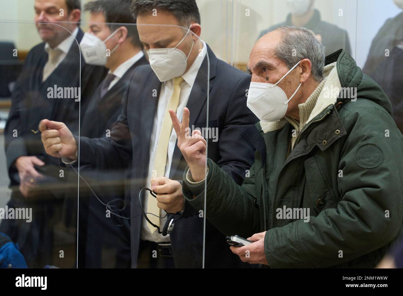 The defendant, Anwar Raslan, right, stands in the courtroom before the ...