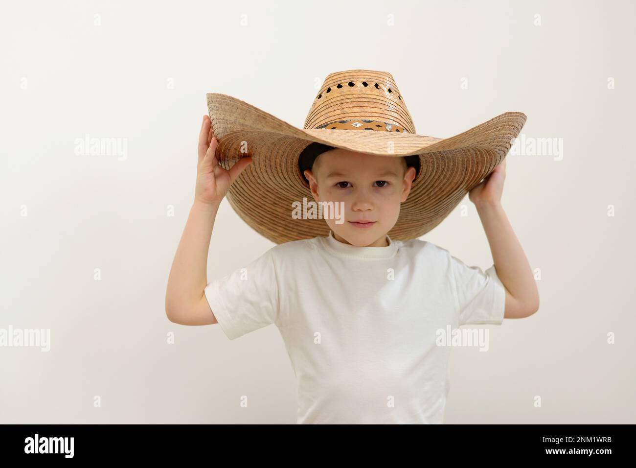 child 4 - 5 years old boy in huge hat big hat on his head white ...