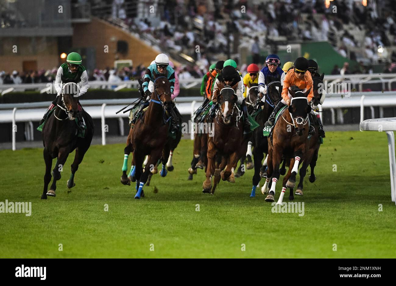Horses gallop into the first turn in the International Jockeys ...