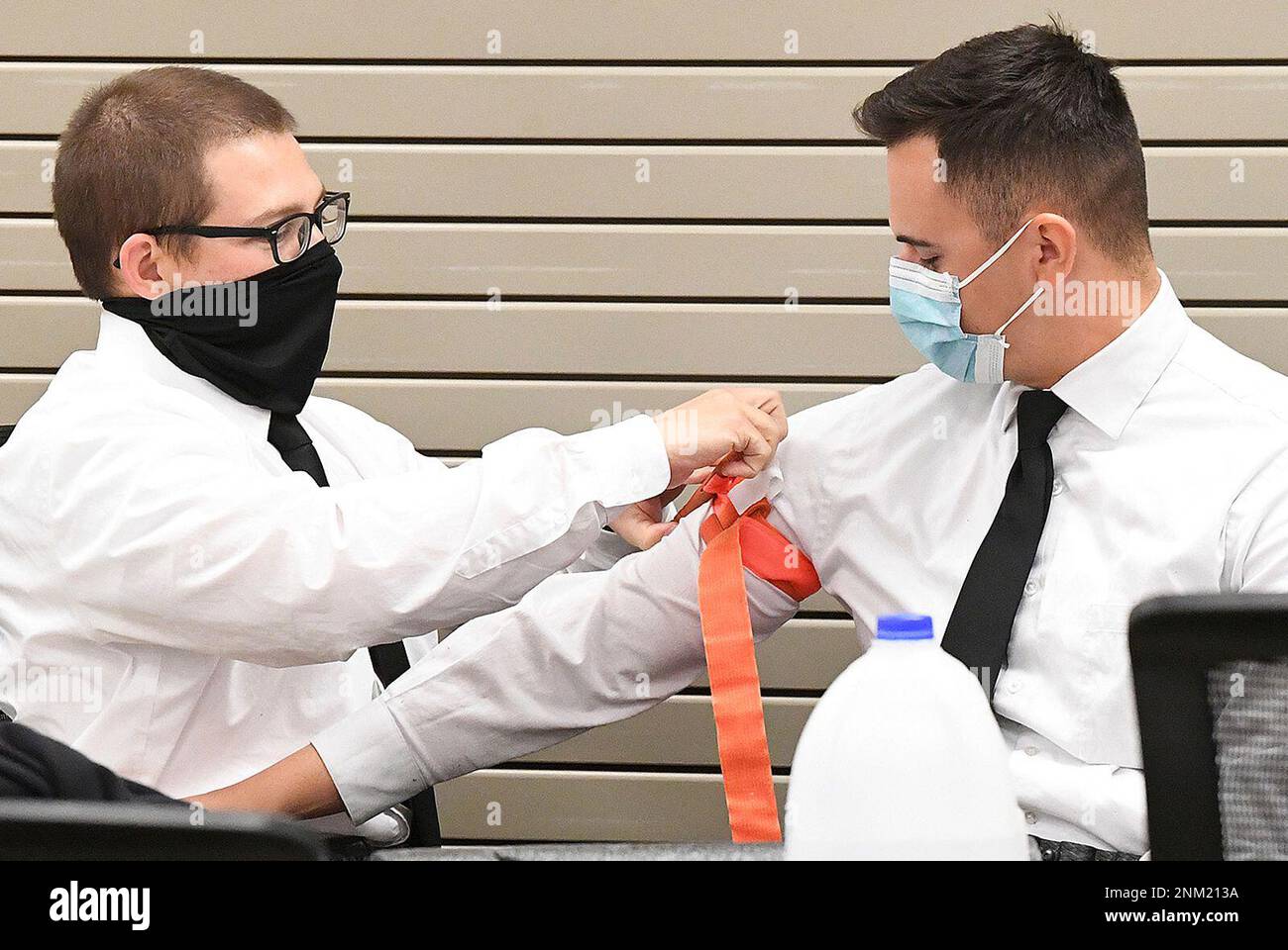 Recruit Robert Endecott (left) applies a tourniquet to the arm of ...