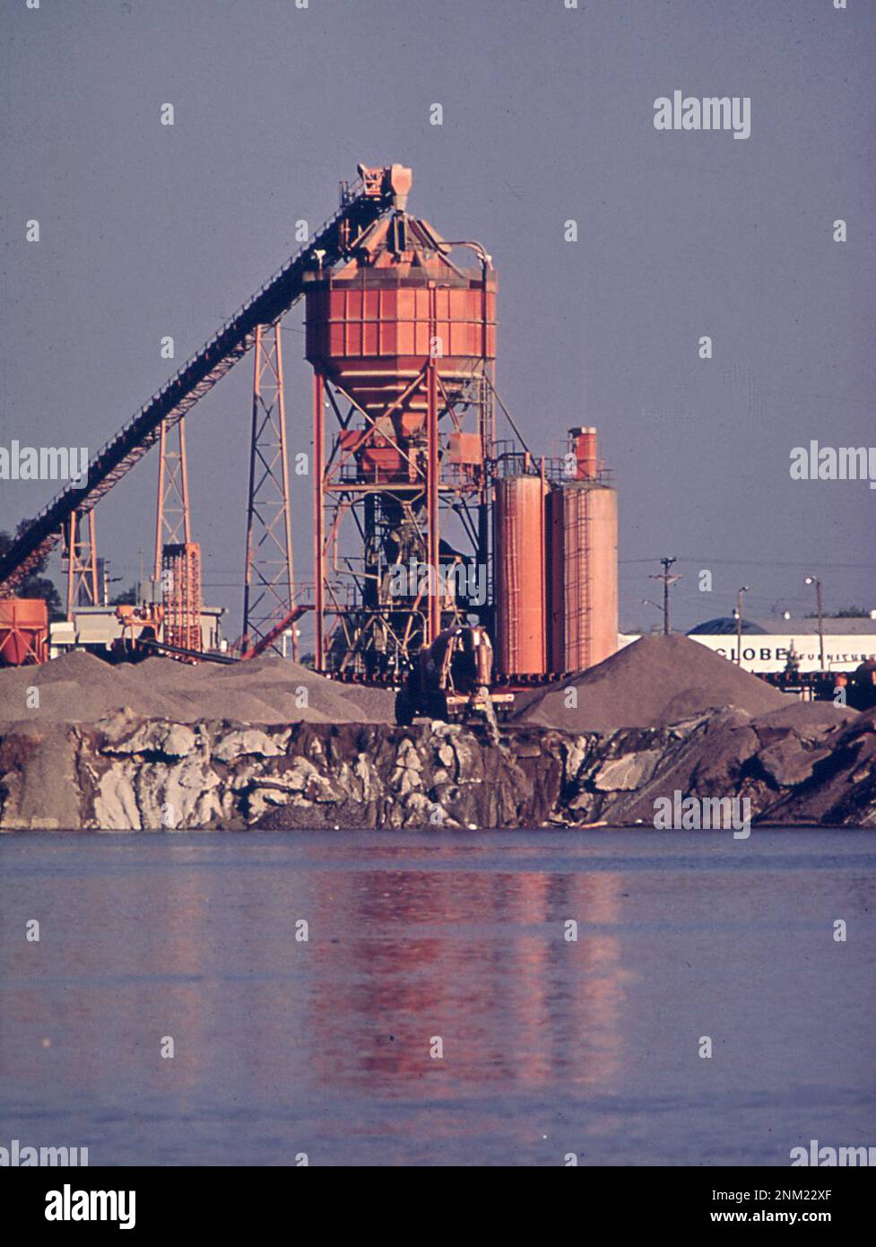 1970s America: Union rock and material plant. The truck is dumping ...