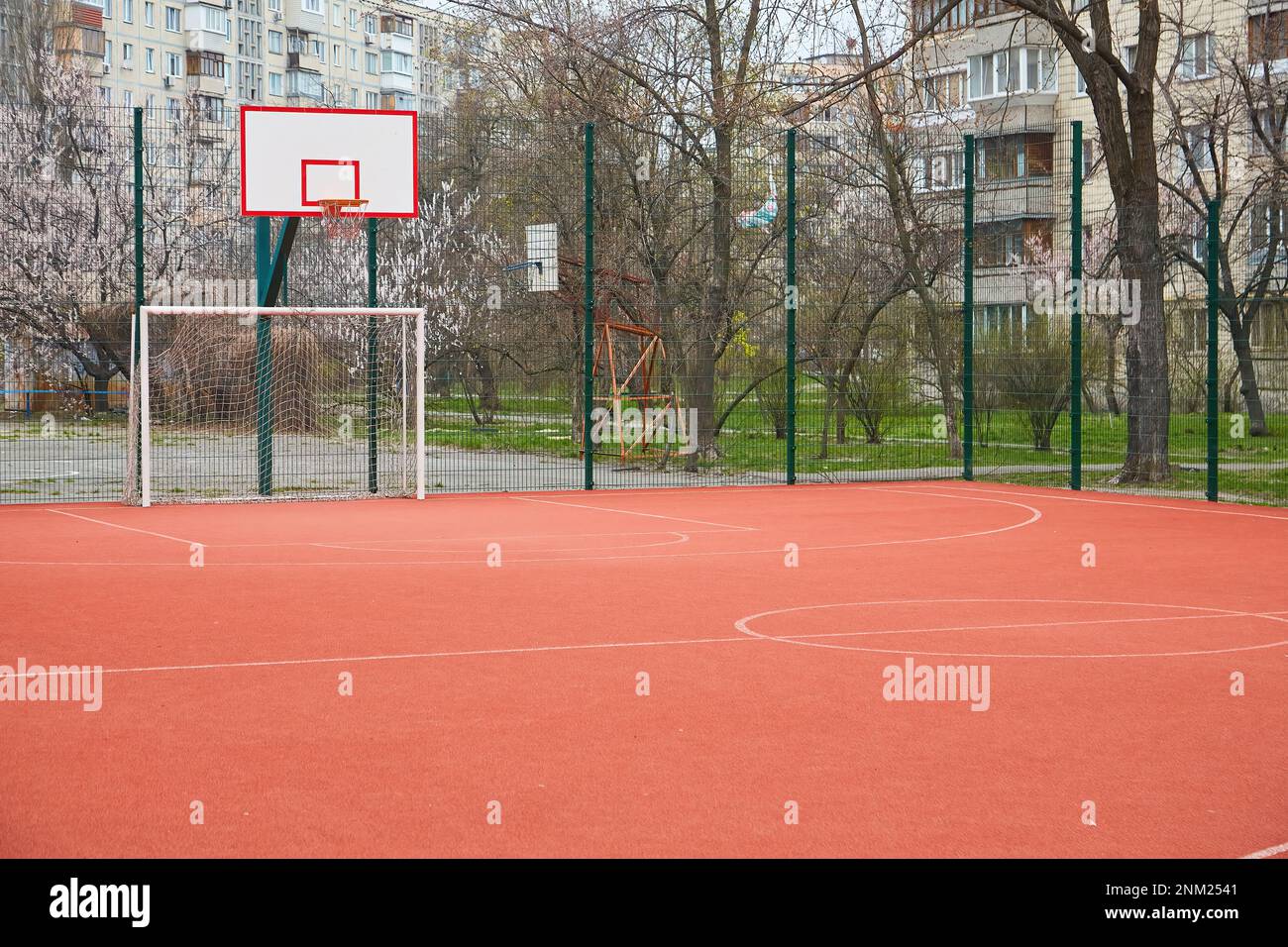 Empty school stadium with synthetic green field and red treadmills in ...