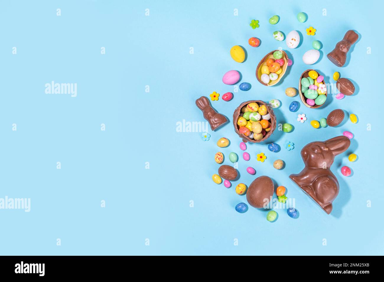 Easter chocolate egg and bunny background. High-colored flat lay with ...