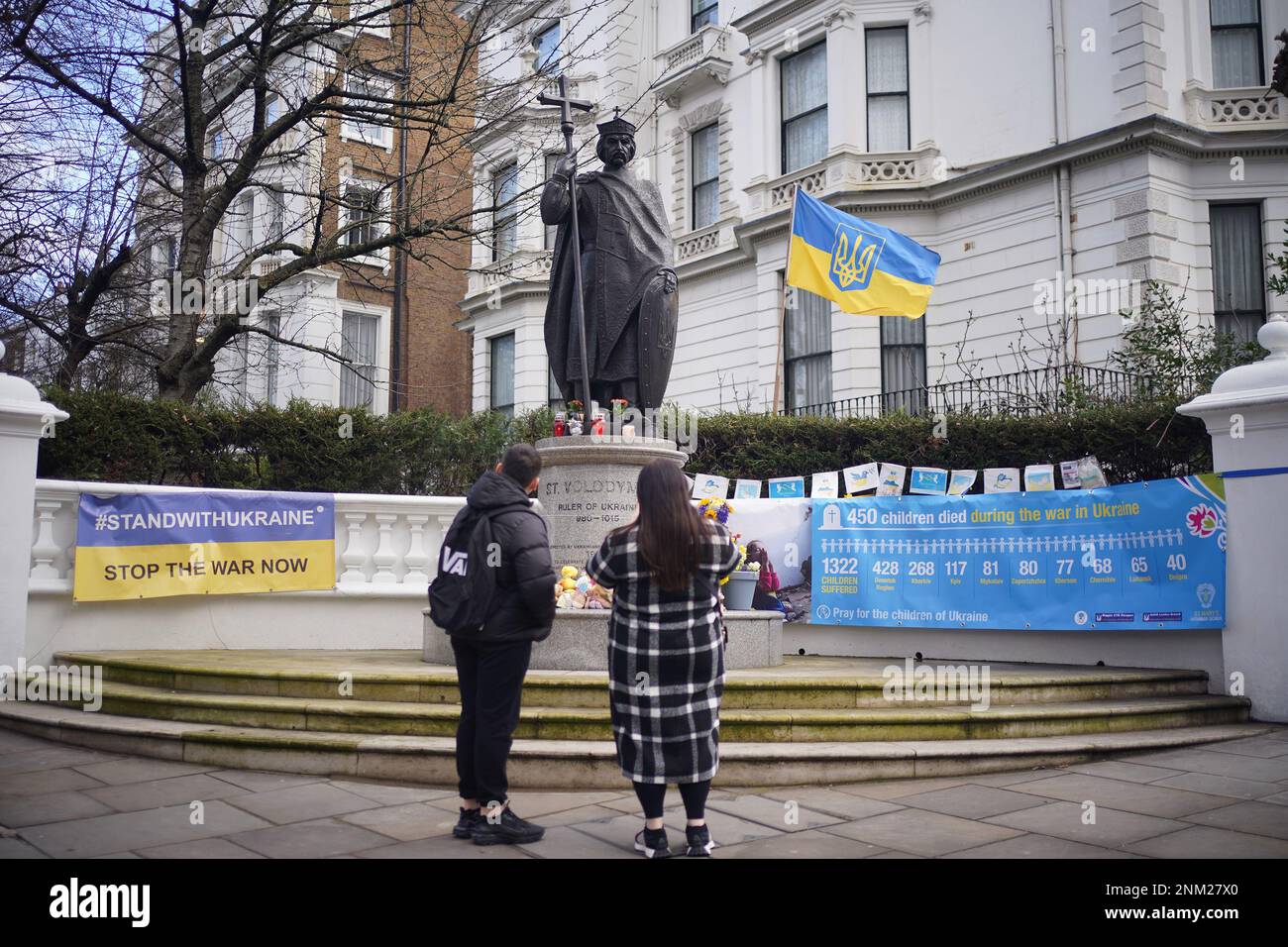 Anti-war banners and a Ukrainian flag surround the St. Volodymyr Statue ...