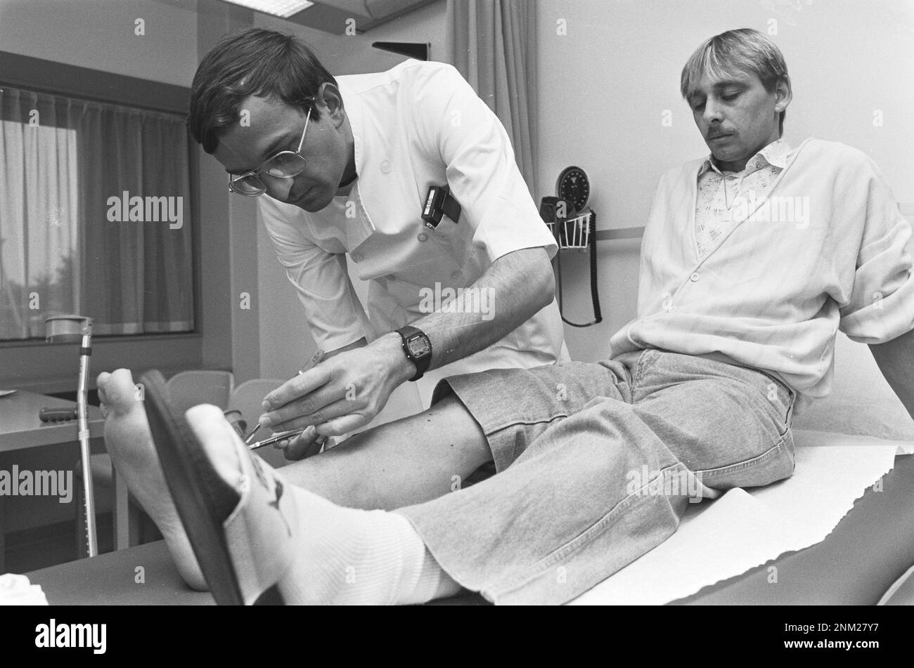 Dr. Patha with a patient in an examination room, looking at an injured ...