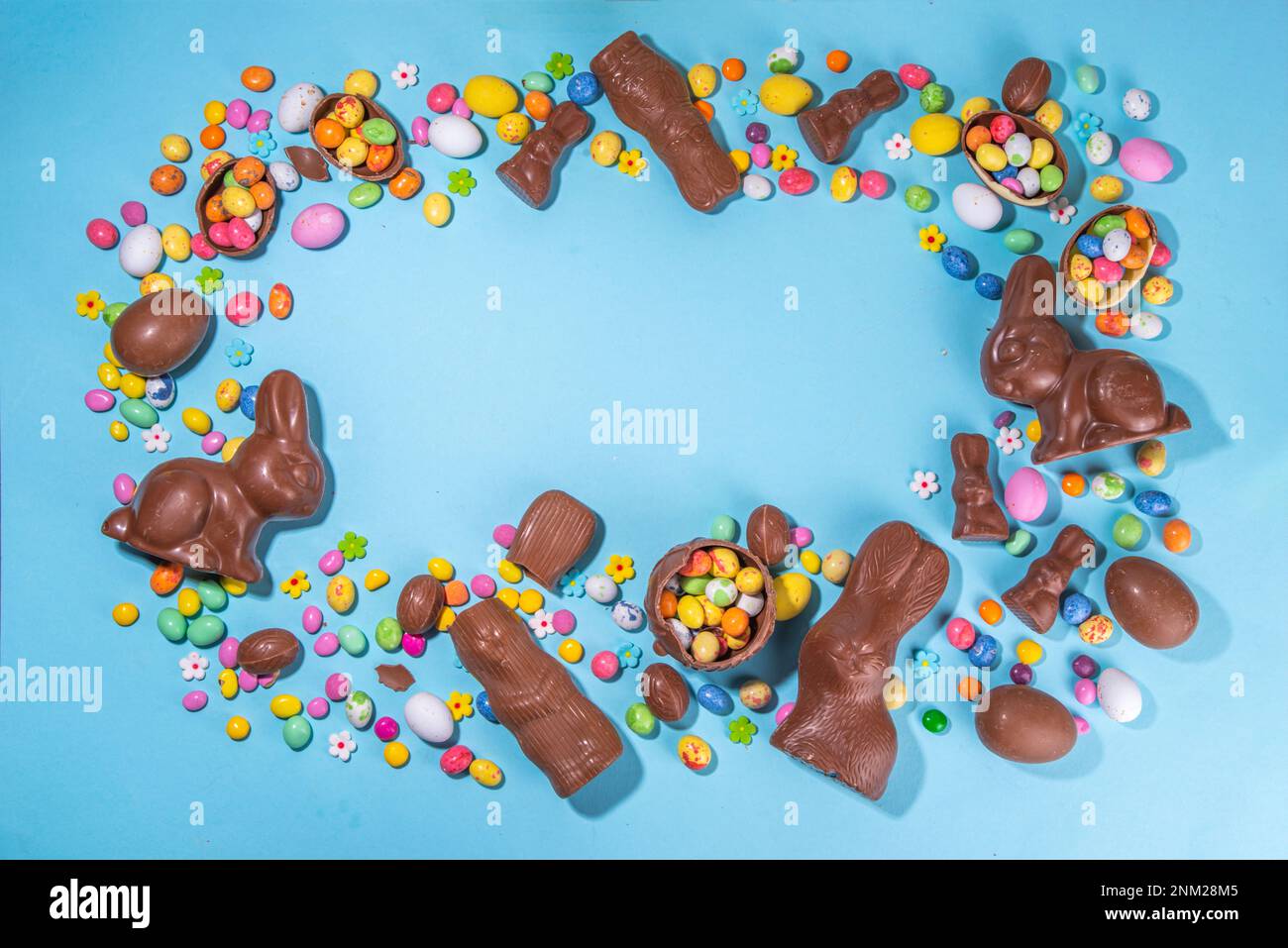 Easter chocolate egg and bunny background. High-colored flat lay with ...