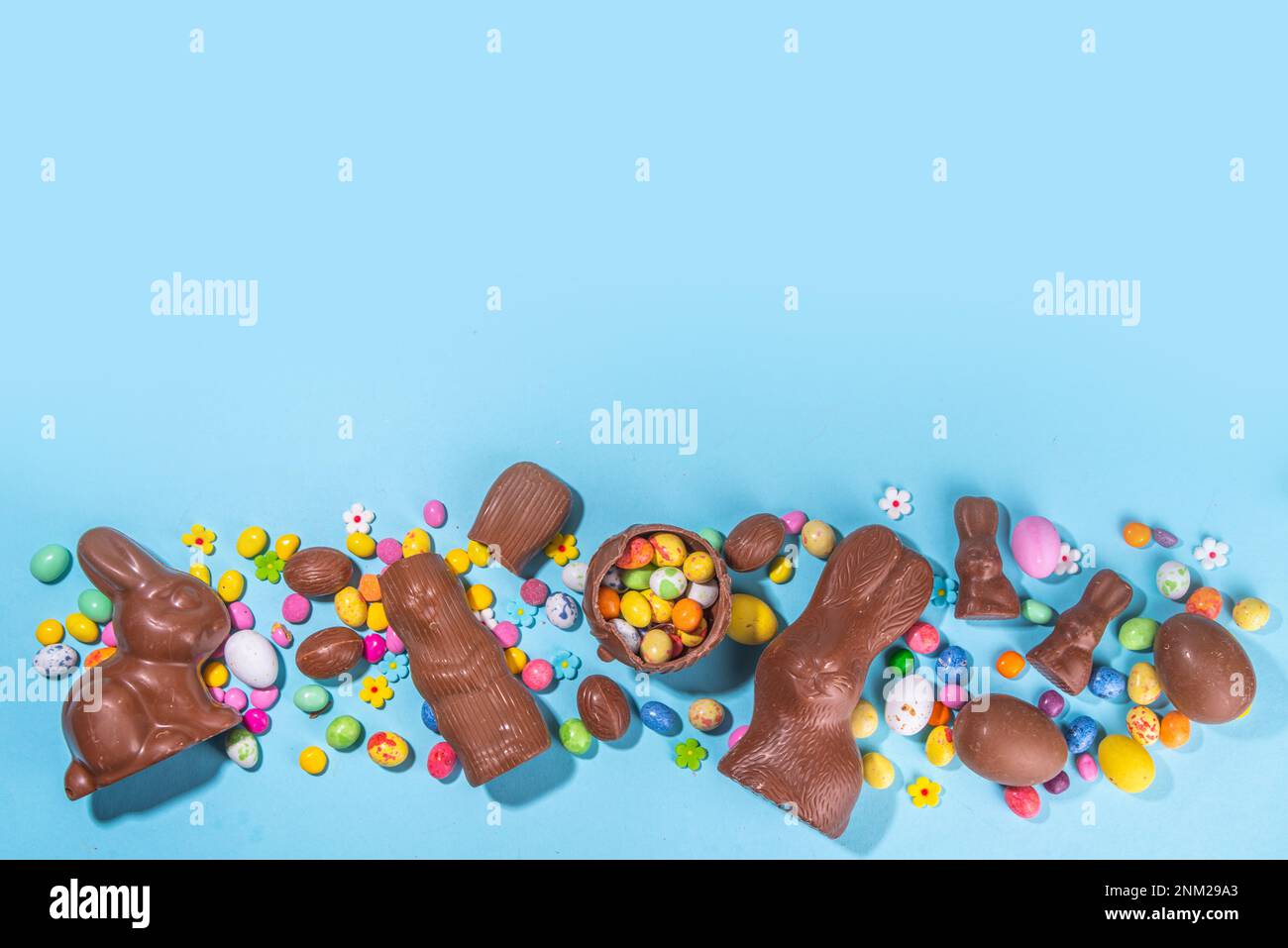 Easter chocolate egg and bunny background. High-colored flat lay with ...