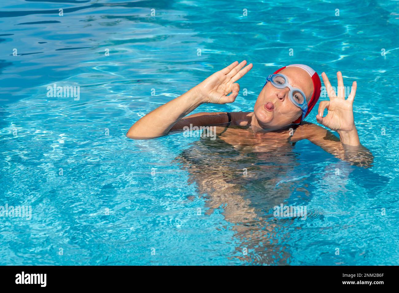 Middle Aged White Woman Is In A Swimming Pool Wearing Goggles And Swim