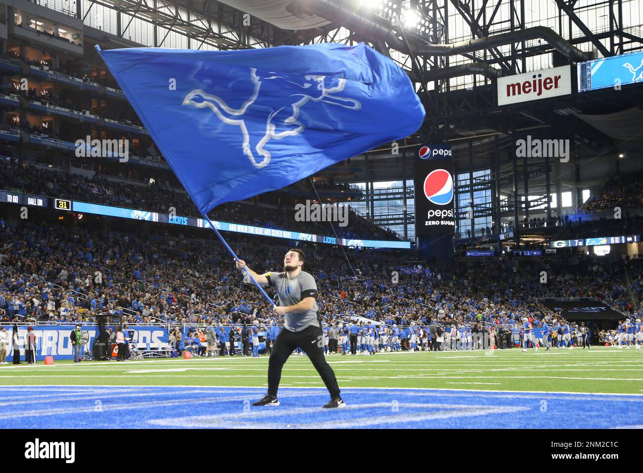 DETROIT, MI - JANUARY 09: A flag bearer waves a Detroit Lions logo flag ...