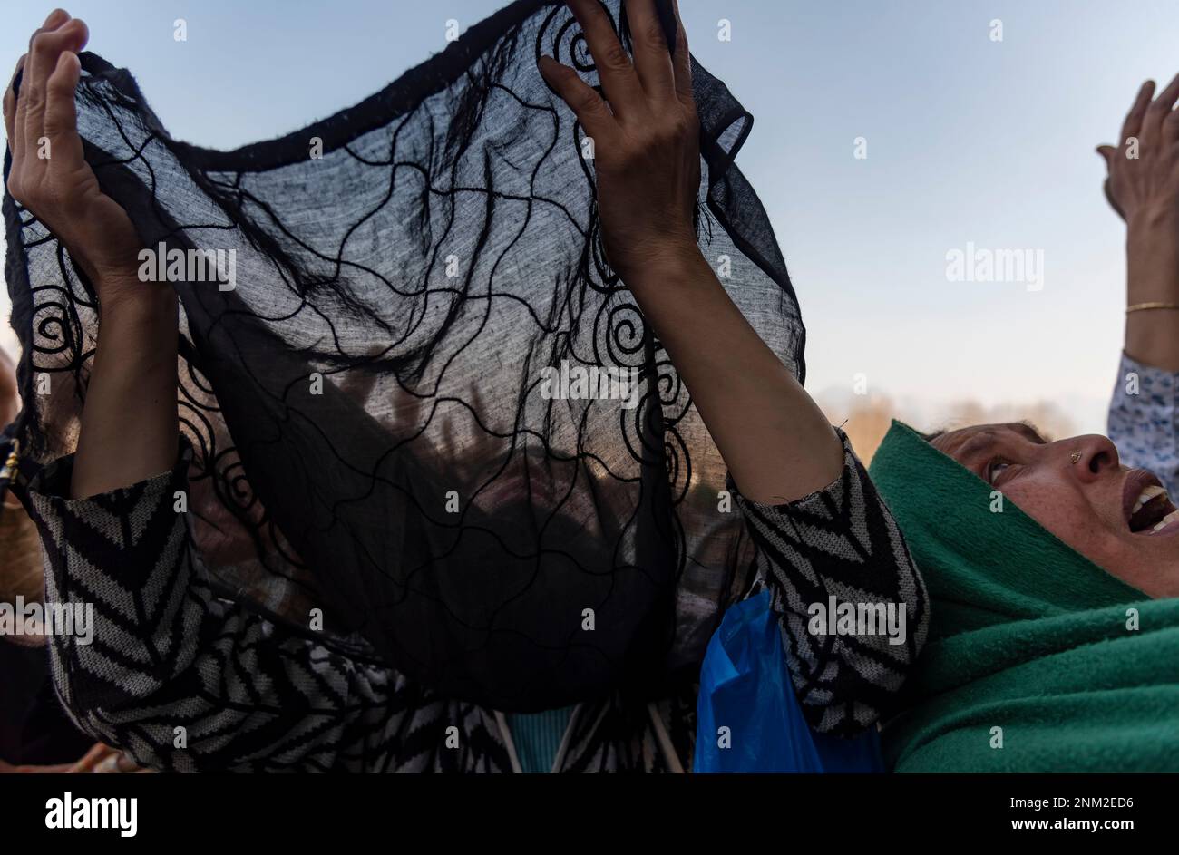 Srinagar, India. 24th Feb, 2023. A Muslim woman raises her hands while ...