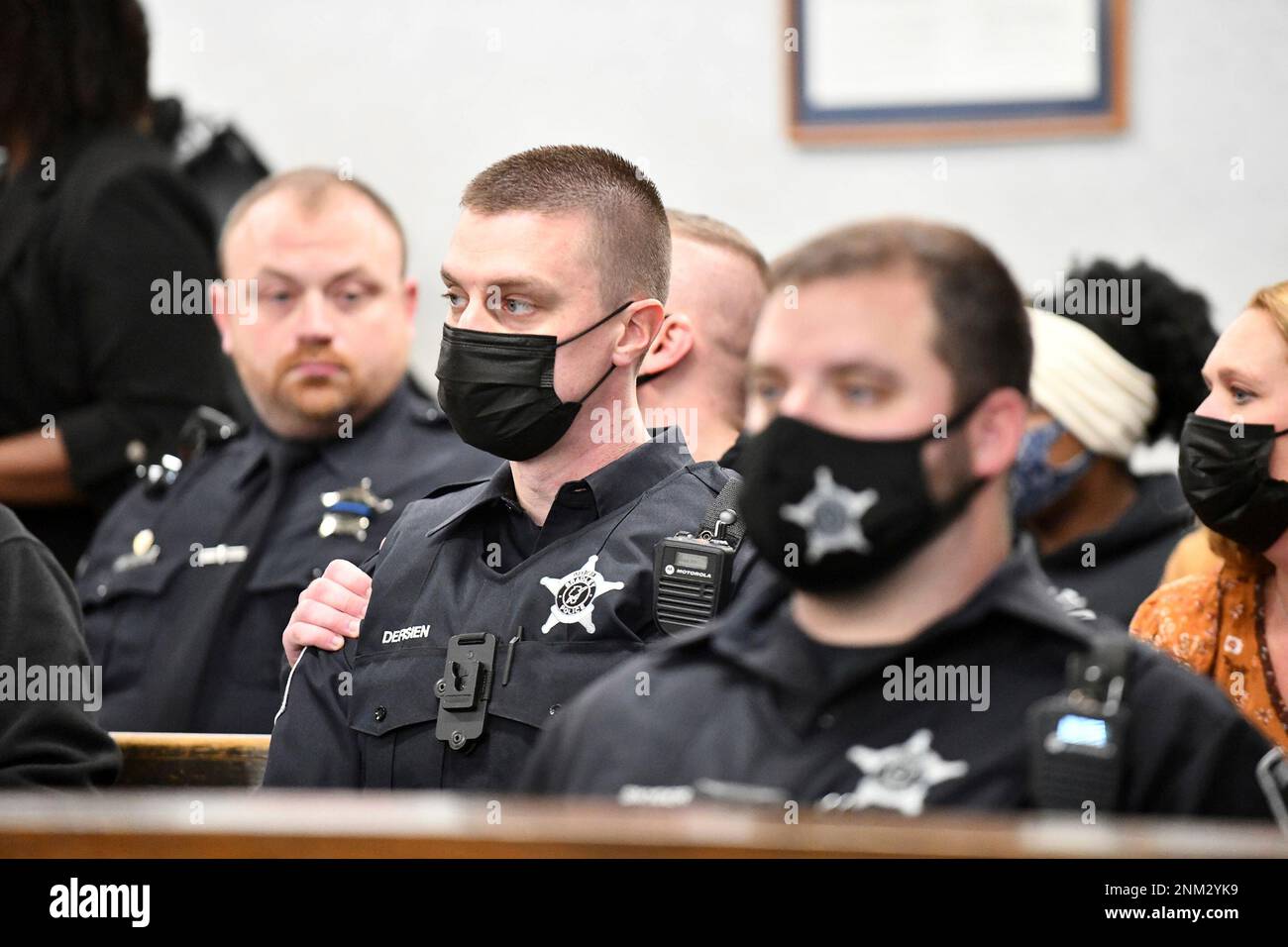 Bradley Police officer Brett Dersein is comforted as the bond hearing ...