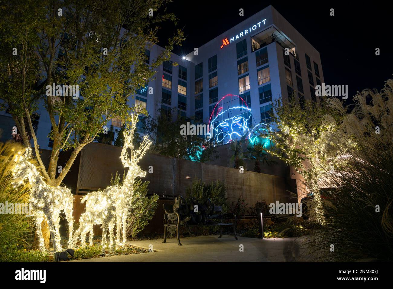 A Christmas light Santa Claus peers over the roof of the Marriott Hotel ...