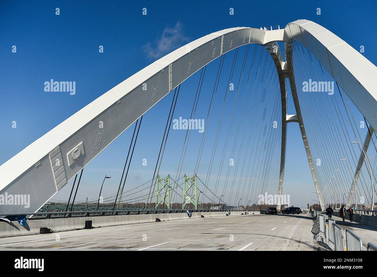 The old I-74 bridge is seen through the arches of the new bridge ...