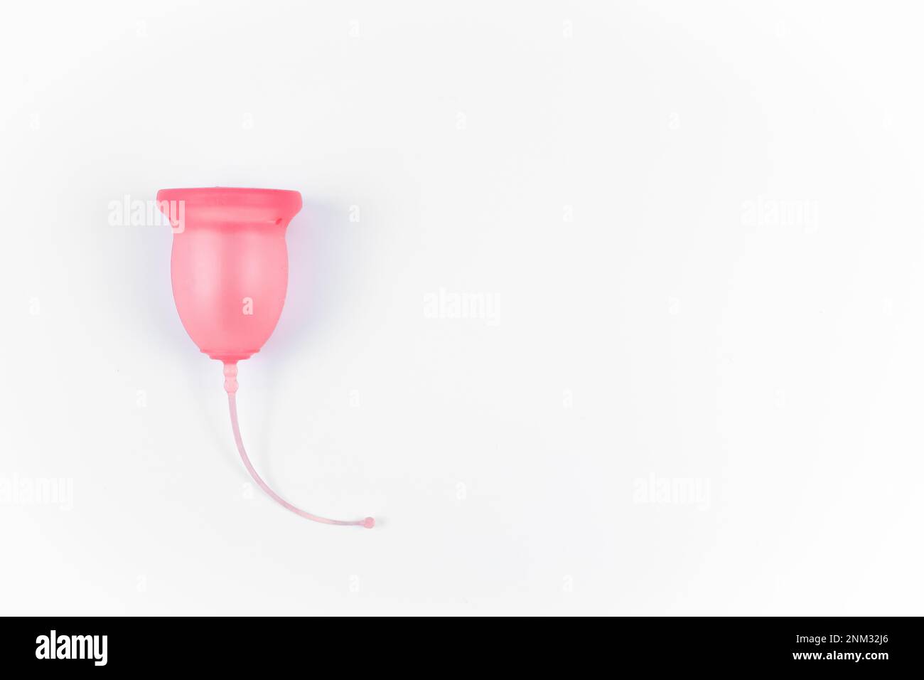 Pink menstrual cup on white background. Alternative feminine intimate ...