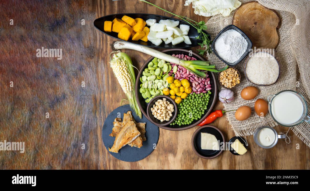 overhead shot of grains, legumes, cod and other ingredients to prepare ...