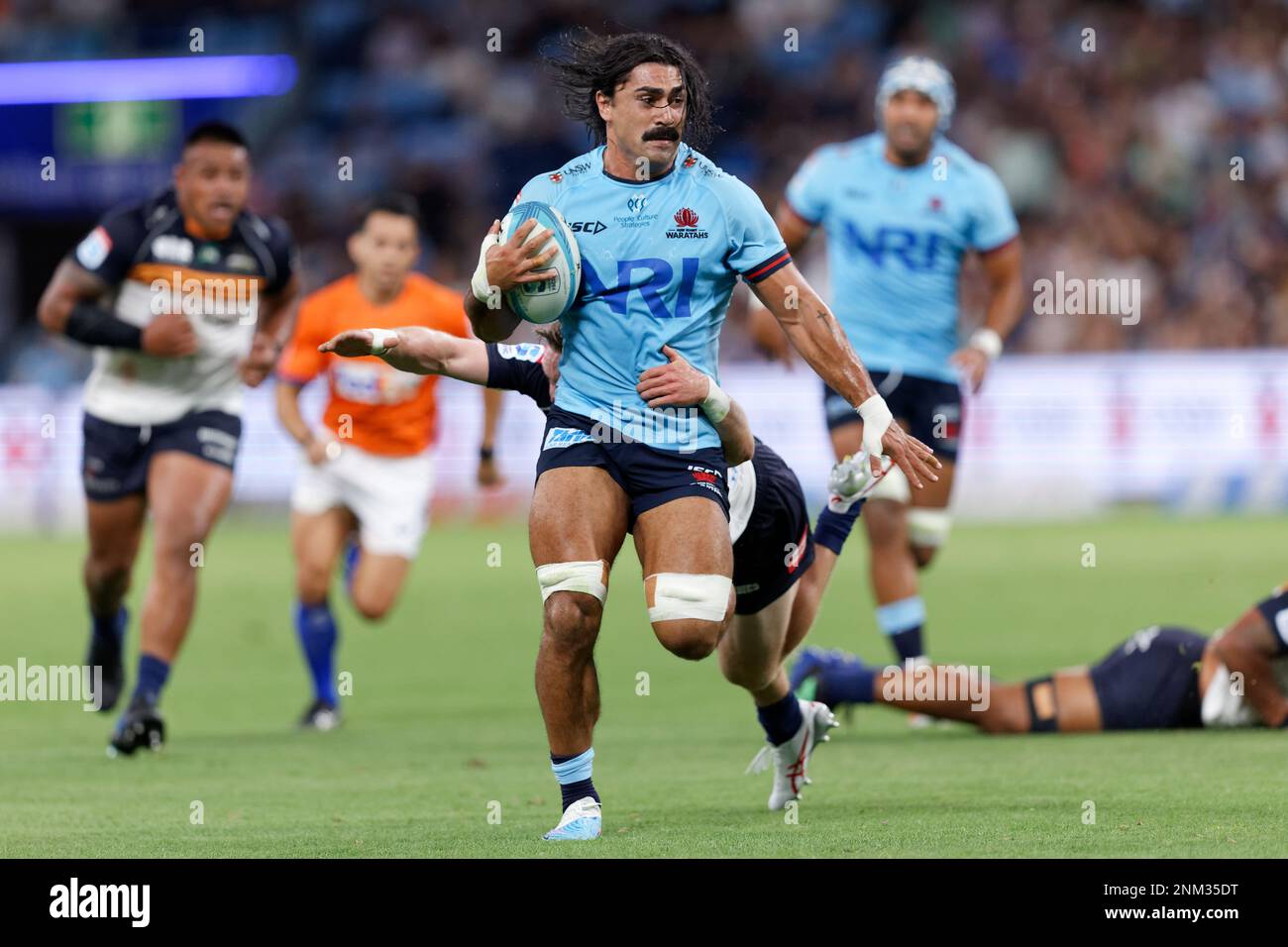 Charlie Gamble of the Waratahs is tackled during the Super Rugby ...