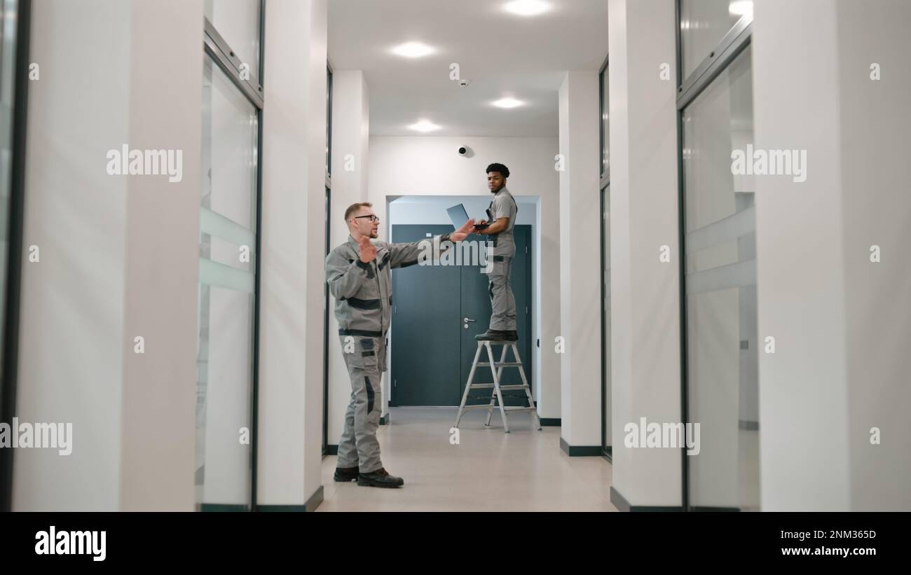 Two multi ethnic installers uniform hi-res stock photography and images ...