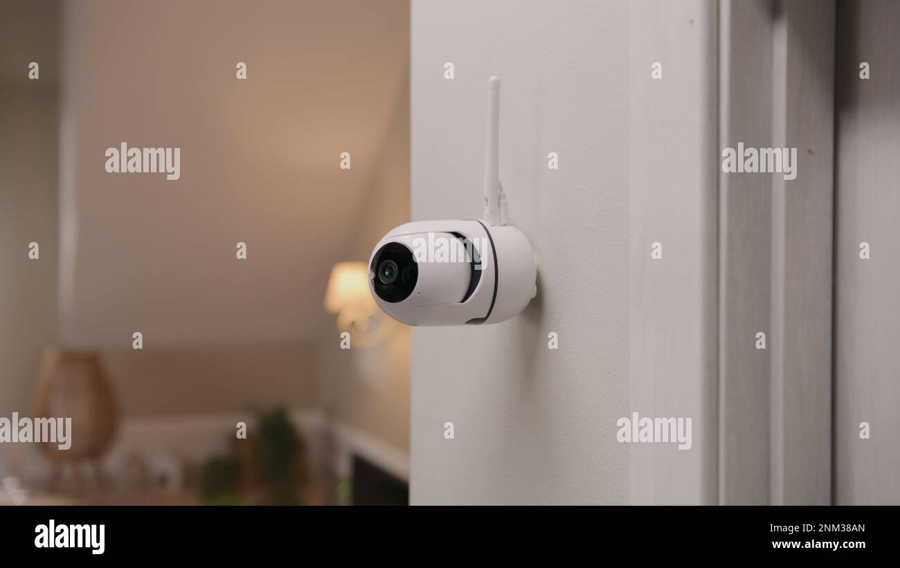 Close up shot of installed security camera on wall in modern apartment ...