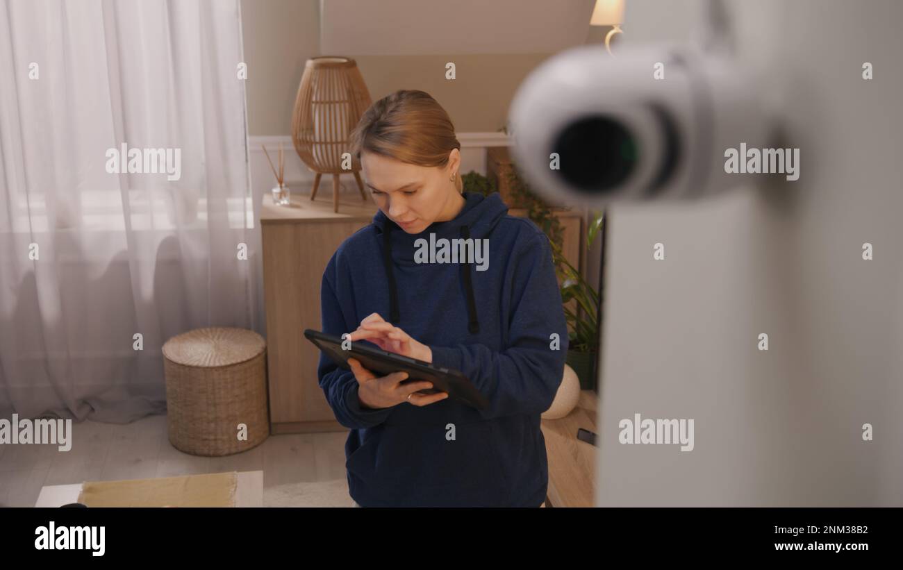 Caucasian Woman Installs Security Camera Woman Sets Up Angle Of Cctv