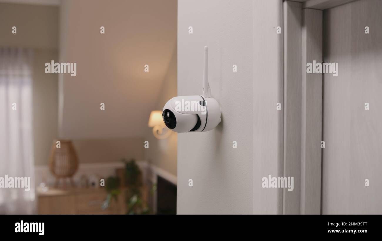 Close up shot of installed security camera on wall in modern apartment ...