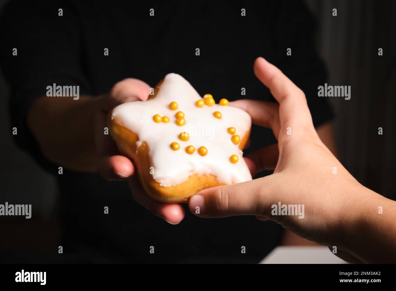 star-shaped doughnut in a woman's hand Stock Photo - Alamy