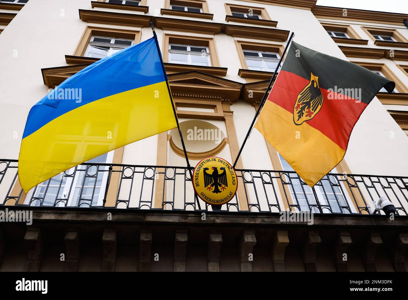 Krakow, Poland. 24th Feb, 2023. Ukrainian flag is seen hanging next to ...