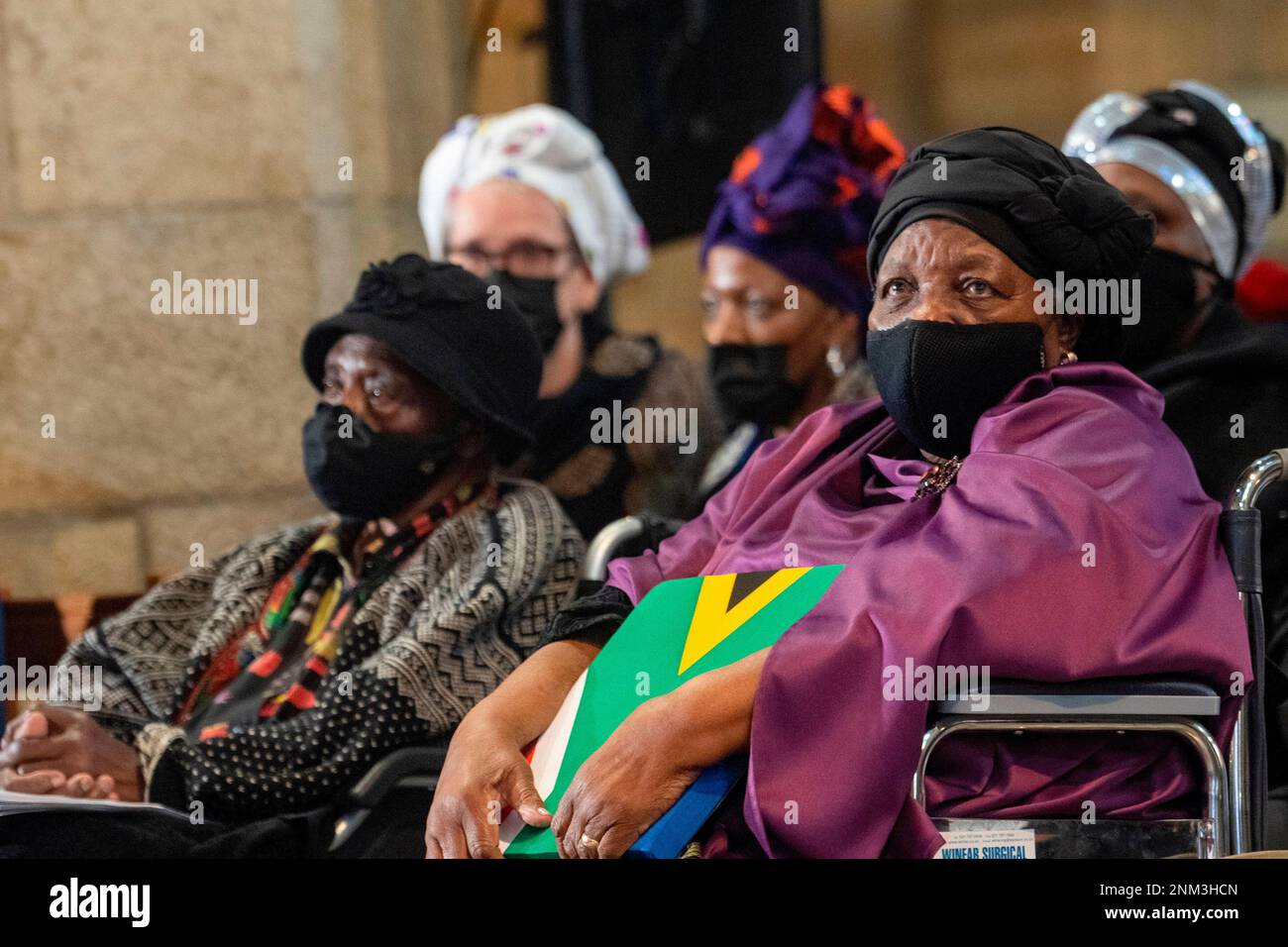 Widow Leah Tutu holds a South African flag presented to her at Anglican ...
