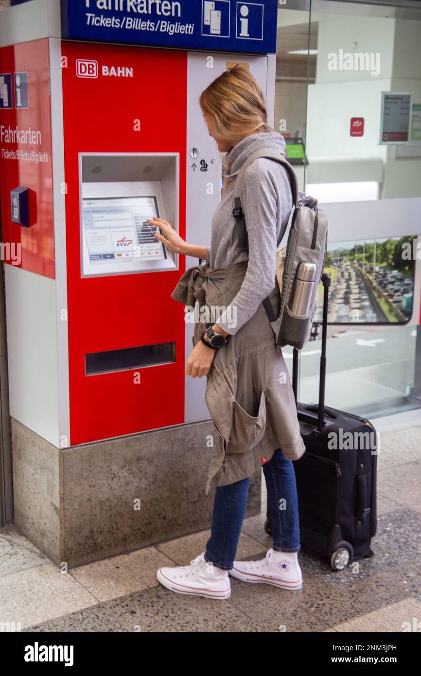 Young woman at the ticket counter in a railway station Stock Photo - Alamy