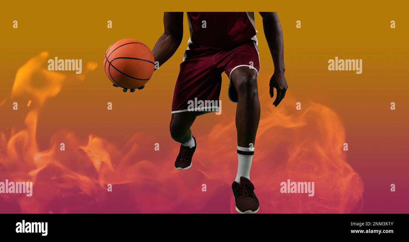 Composition of low section of male basketball player holding ball, over ...