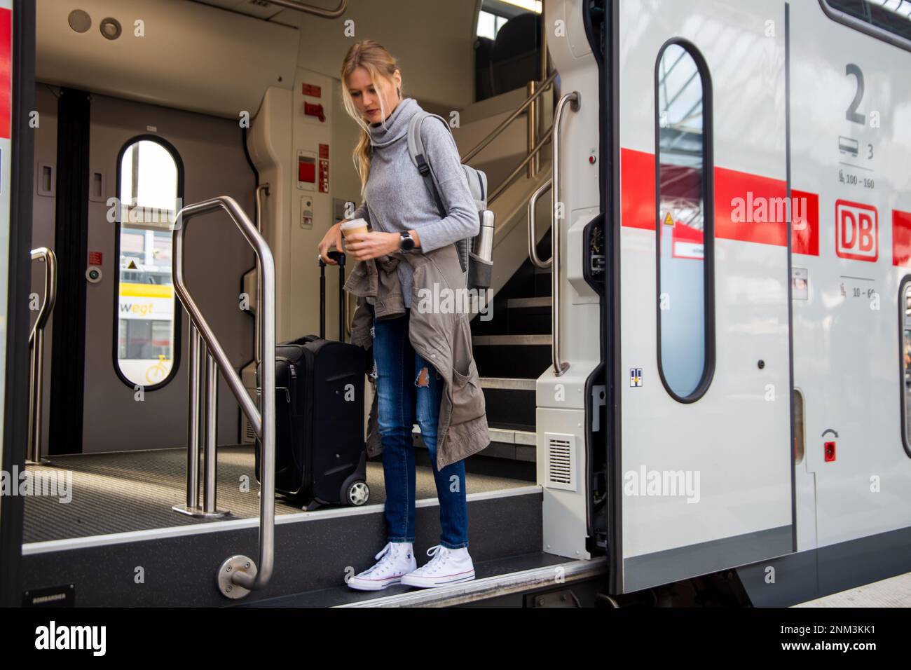 Young woman gets on a Deutsche Bahn Intercity train (Model released ...