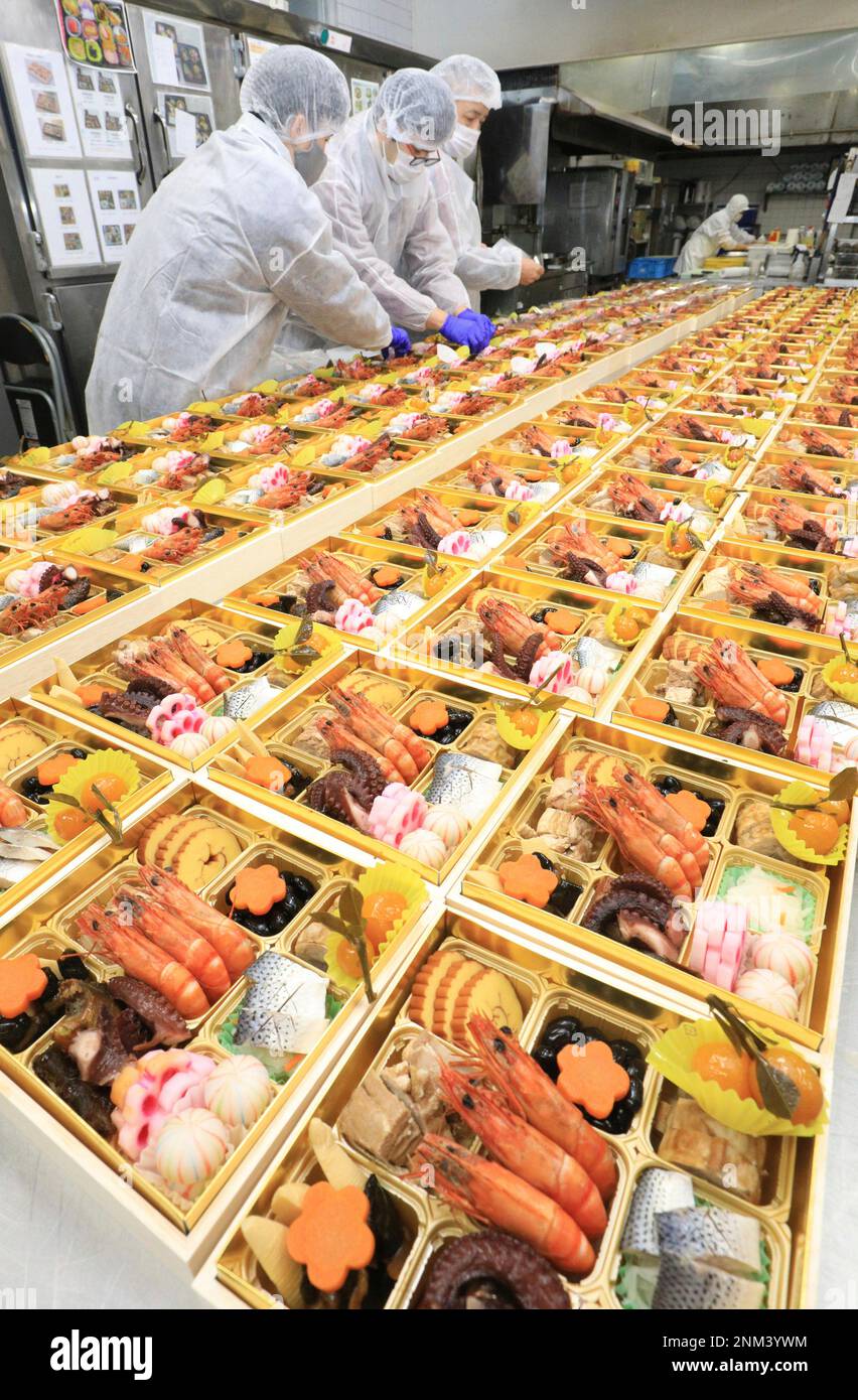 Workers are busy packing Osechi Ryori in ju-bako boxes in Fukuoka City ...