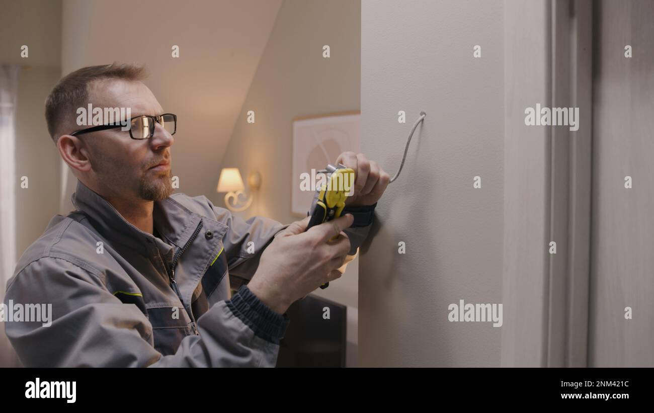 Electrician removes insulation from hi-res stock photography and images ...