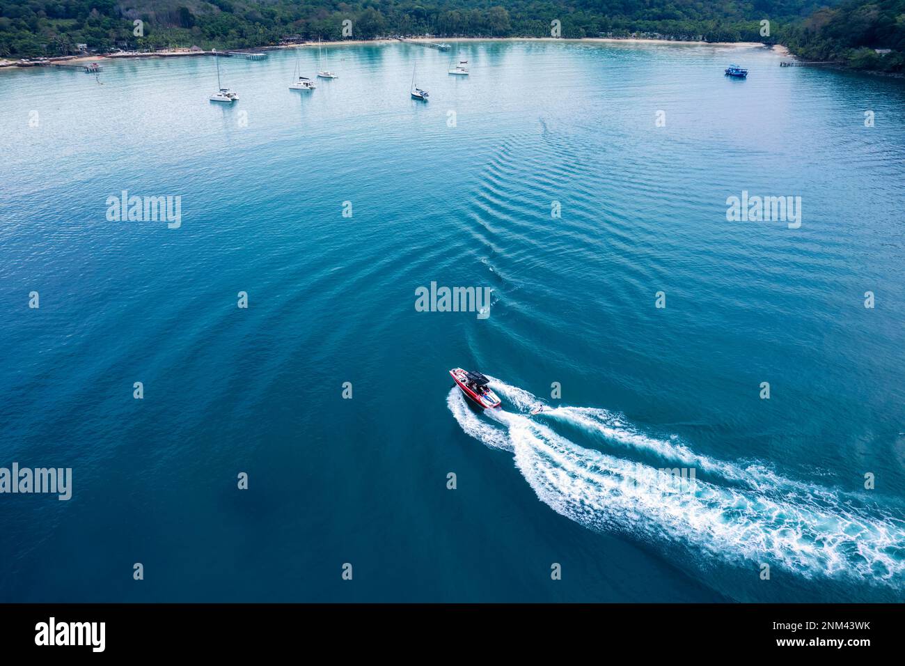 Aerial view of speedboat sailing and rippled on tropical sea in summer ...