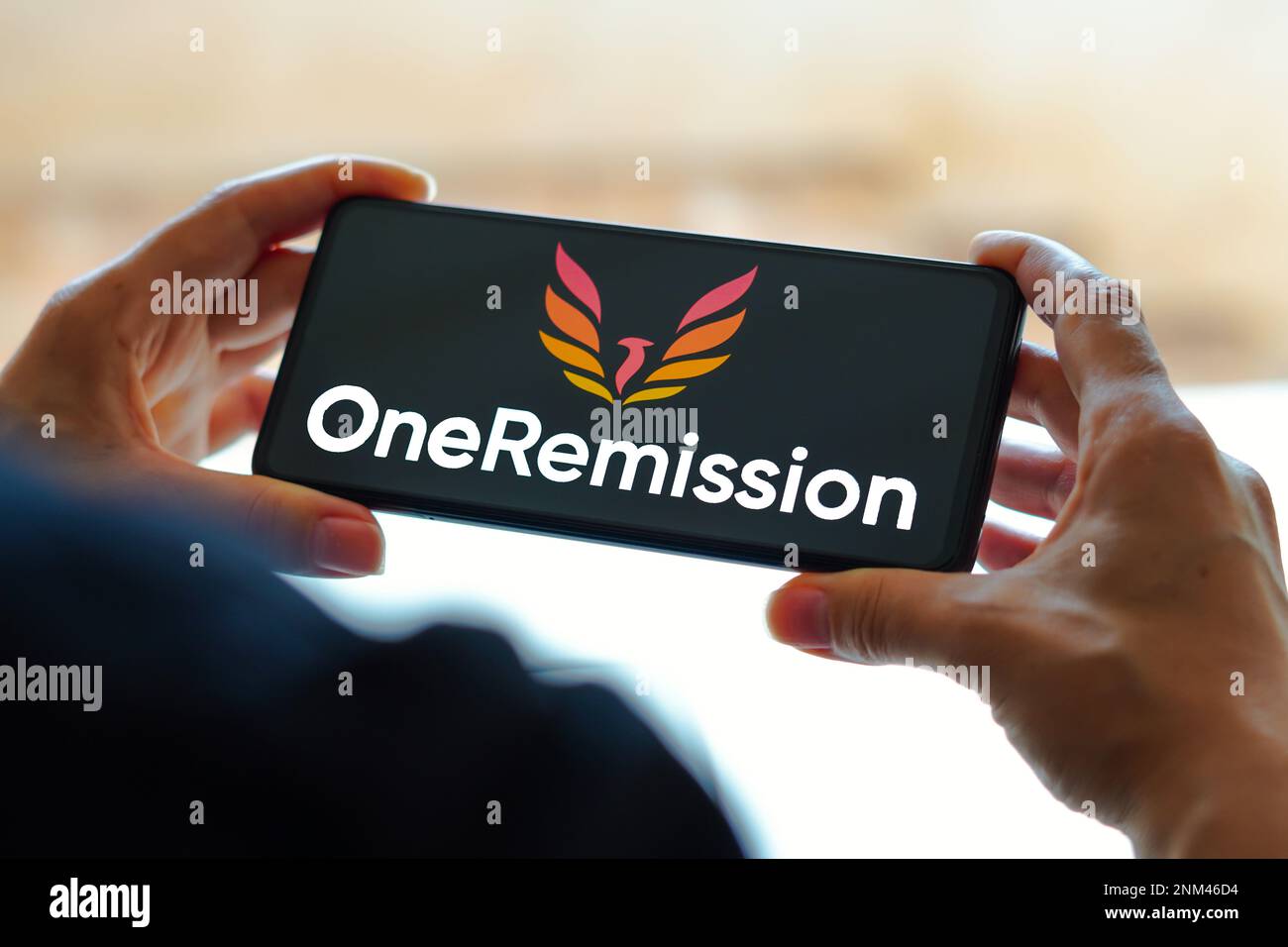 In this photo illustration the OneRemission logo seen displayed on a ...