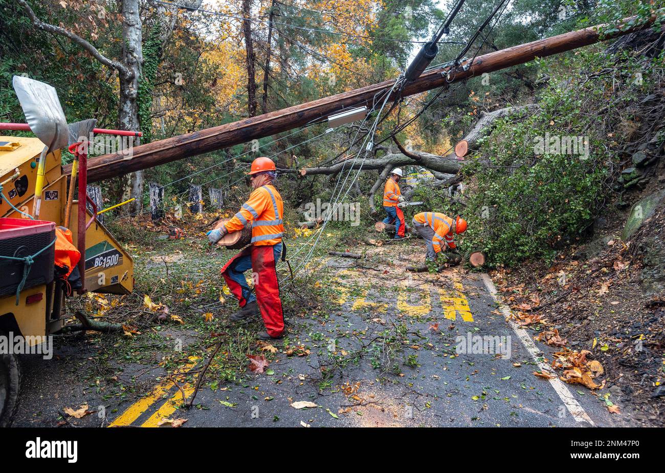 Crews work at cutting up a large tree that fell across Silverado Canyon ...