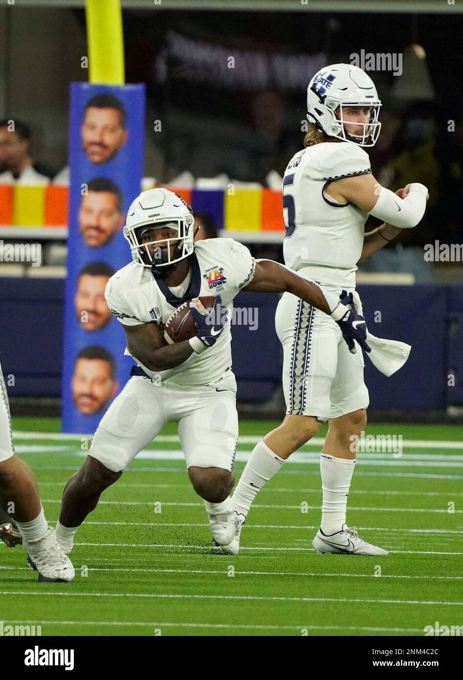 Utah State running back Calvin Tyler Jr. (4) makes a play with the ...