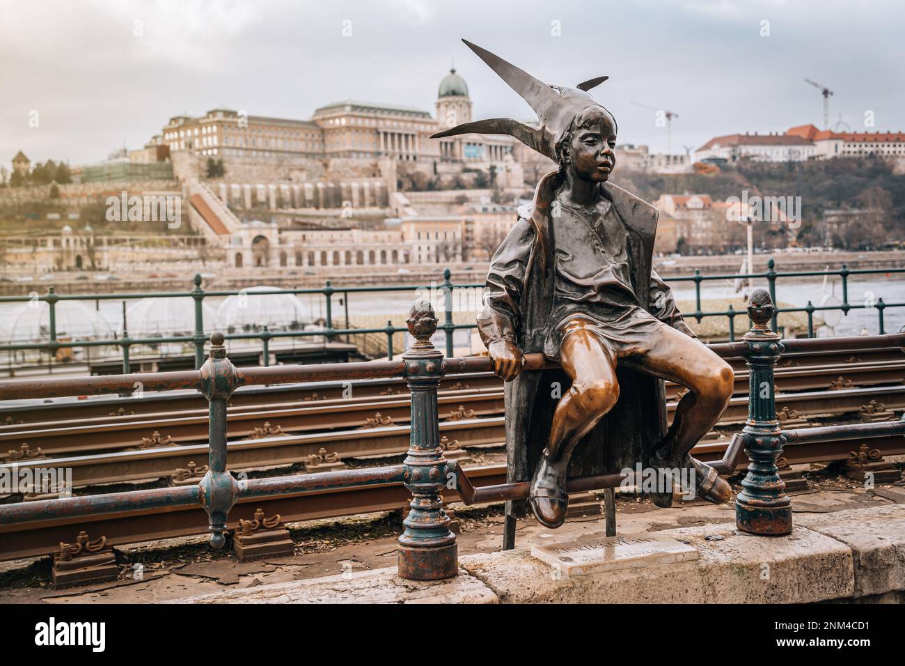 Little Princess statue or Kiskiralylany sitting on the railings of the Danube promenade ...