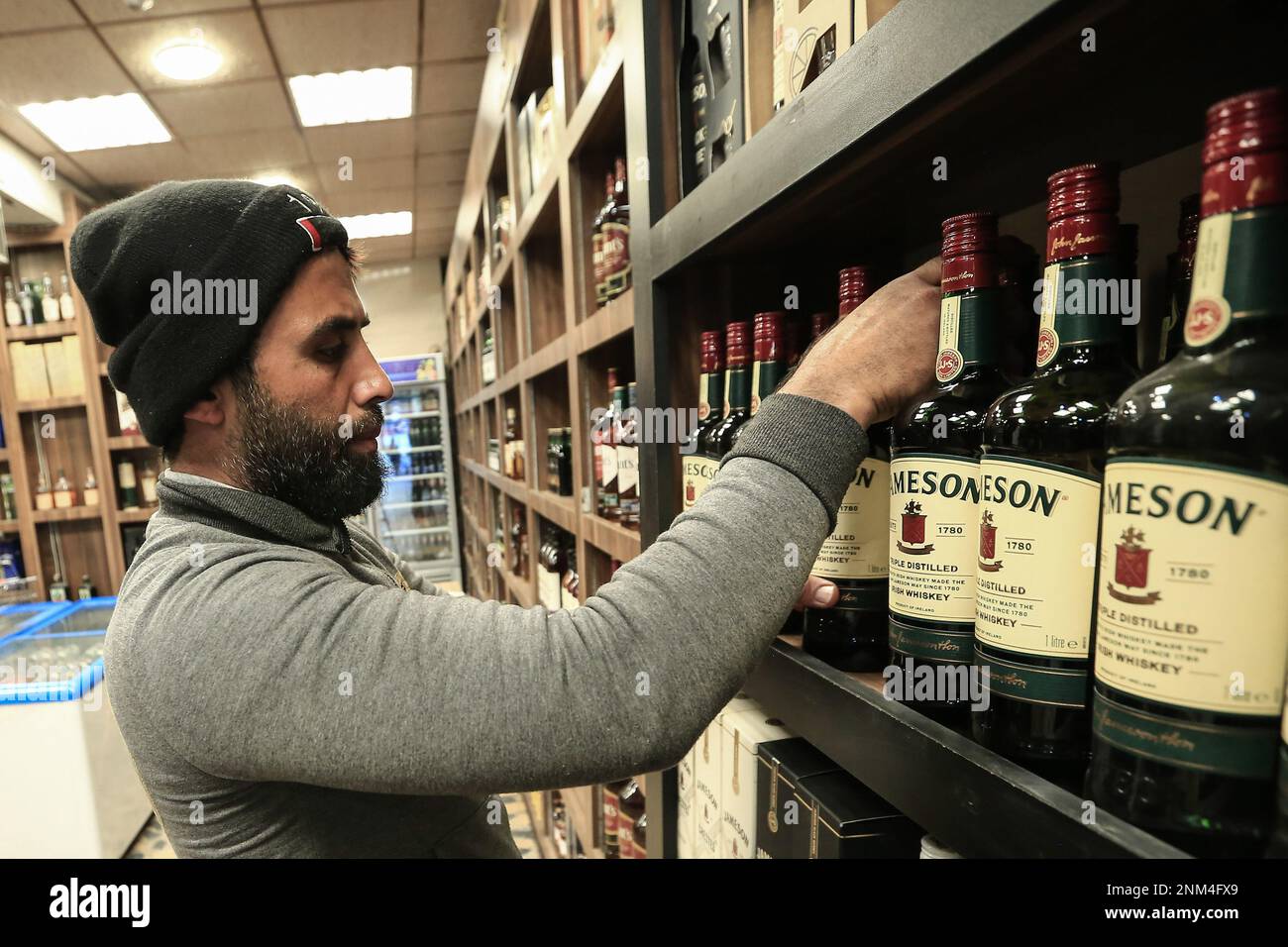 Baghdad, Iraq. 24th Feb, 2023. A man works at a shop selling alcoholic ...