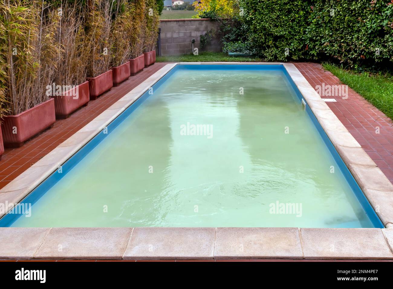 A swimming pool has white water due to shock chlorination Stock Photo ...
