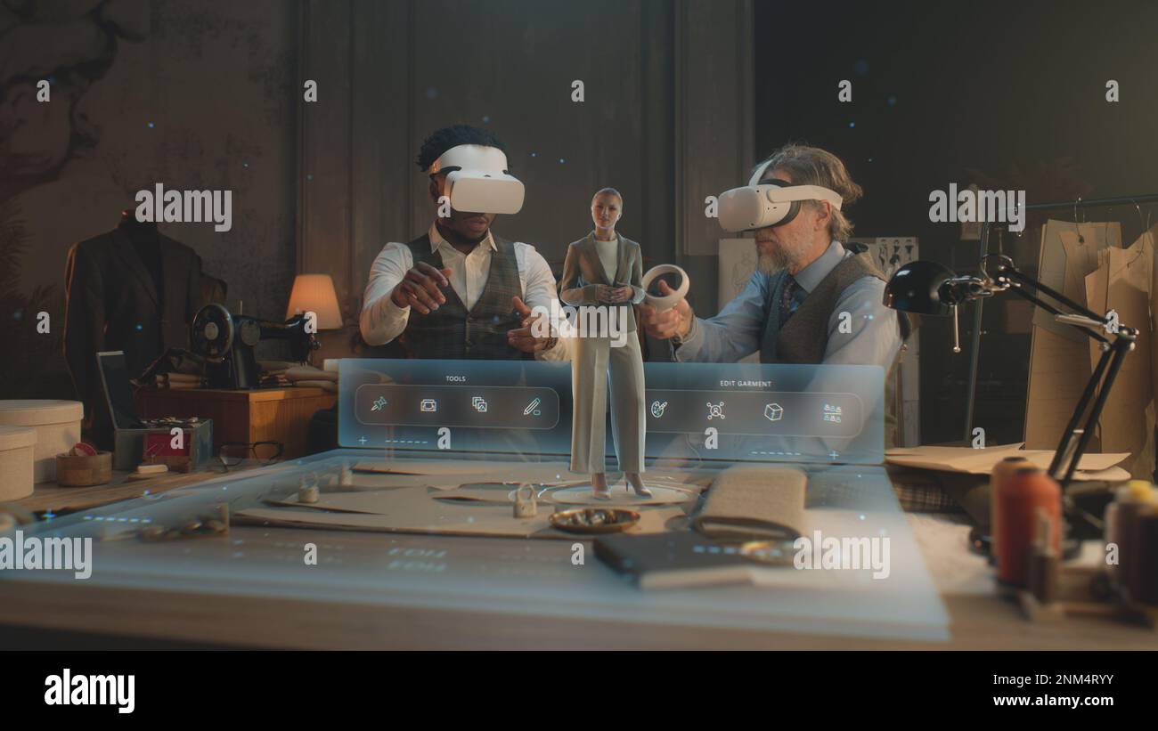 Two multi ethnic tailors in VR headsets in atelier. 3D female hologram ...