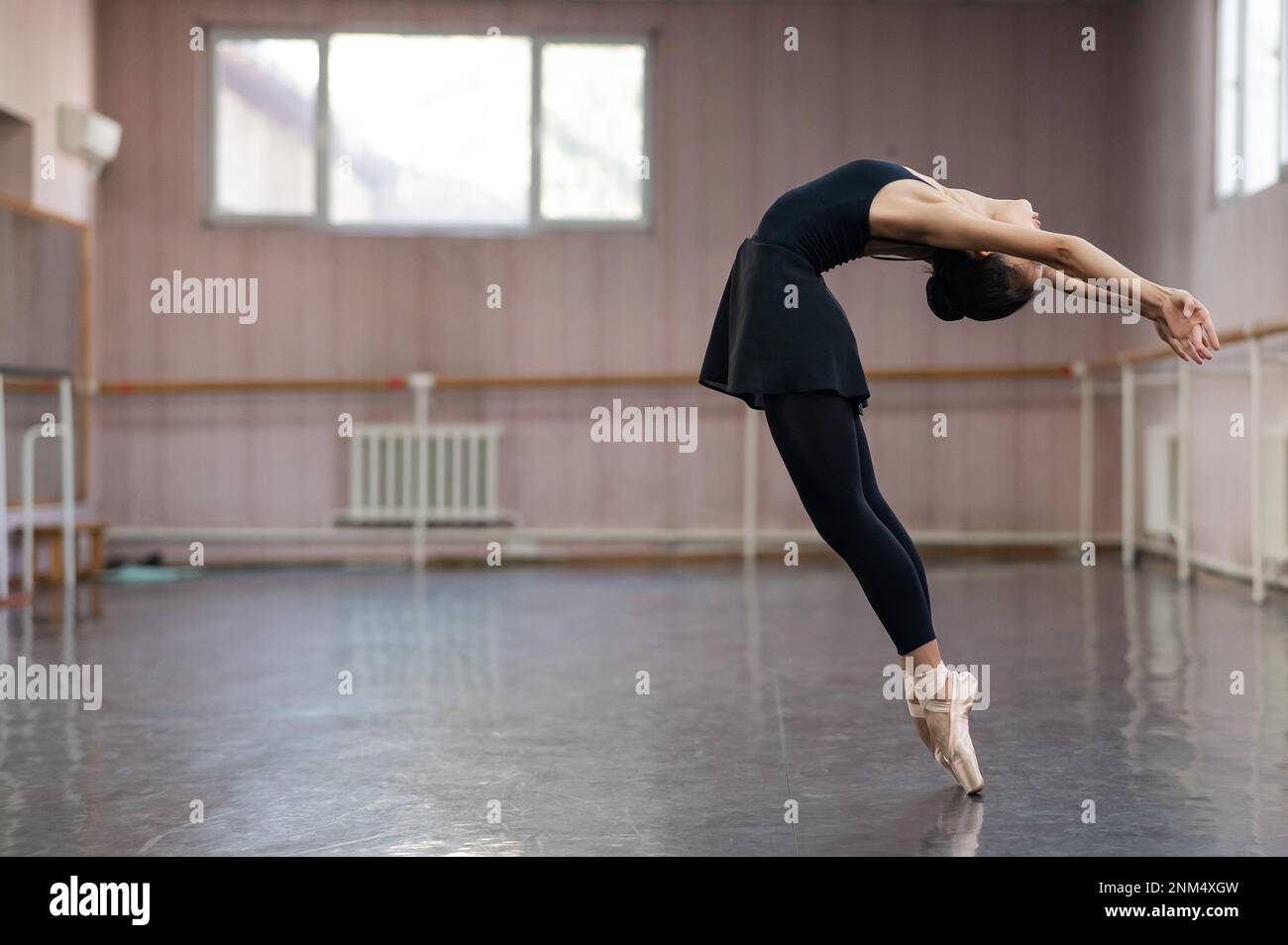 Asian woman dancing in ballet class. Bending in the back Stock Photo ...