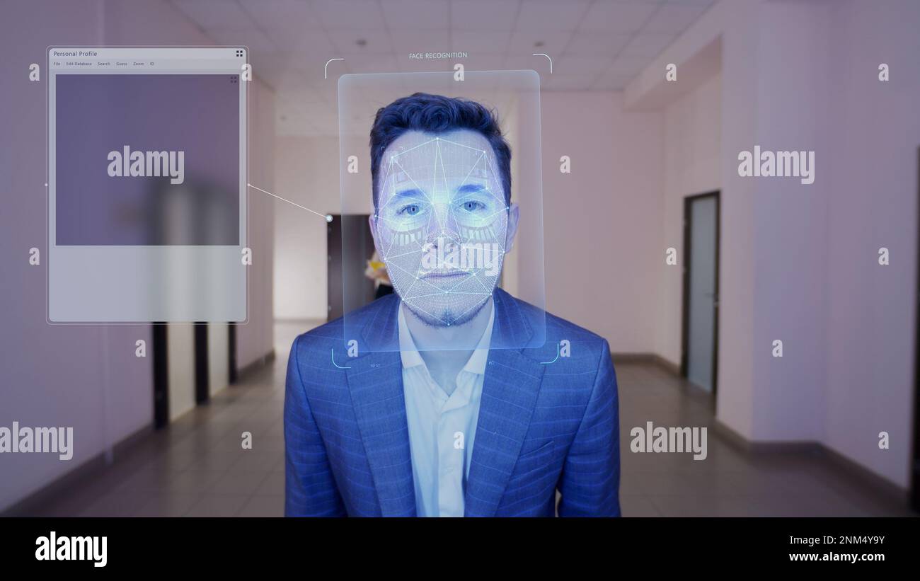 Businessman scans face in office. He touches sensor and security system ...