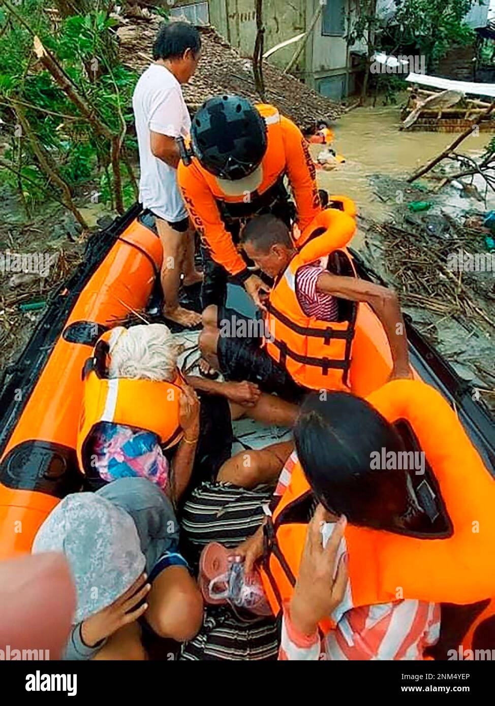 In this photo provided by the Philippine Coast Guard, rescuers assist ...
