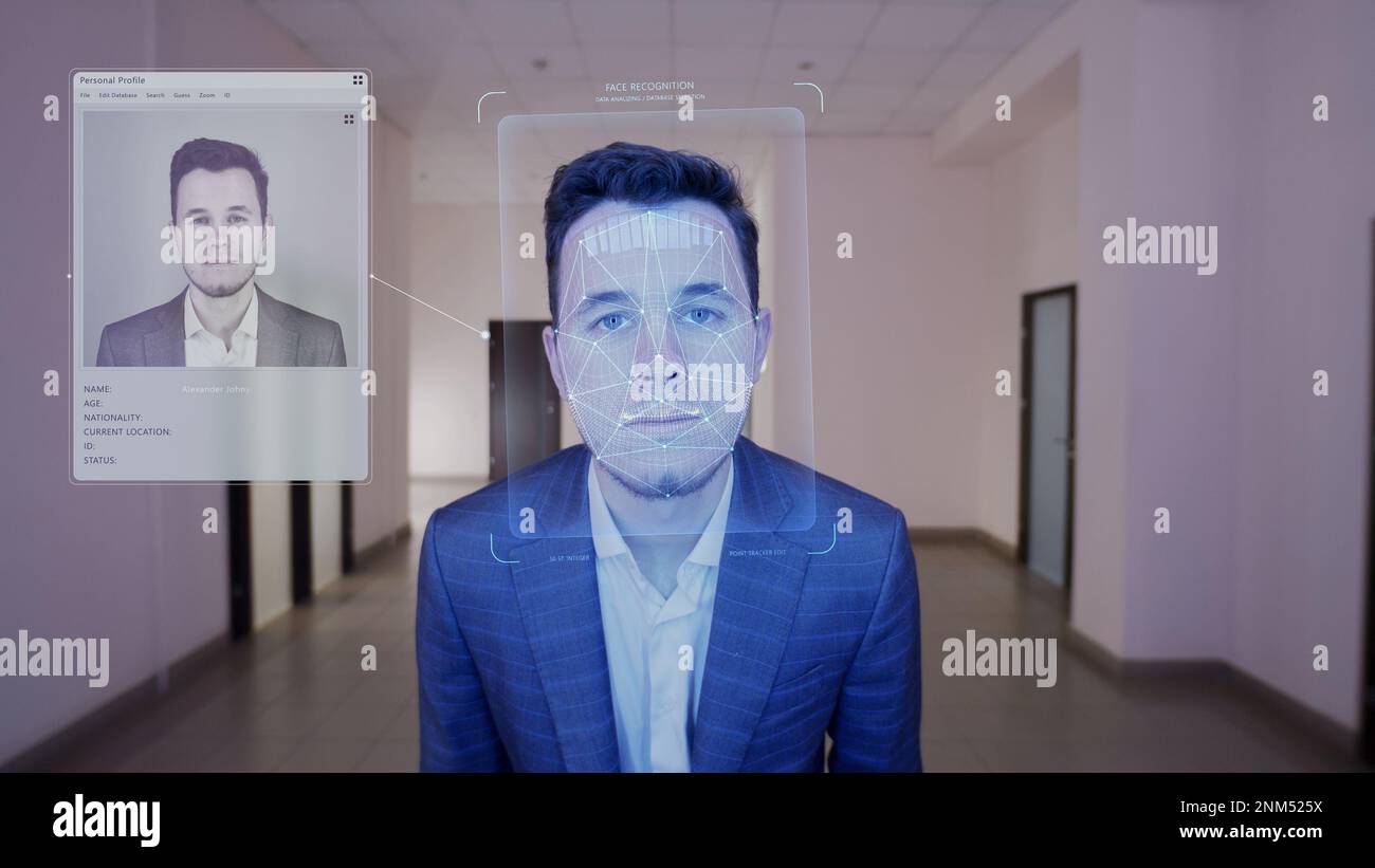 Businessman scans face in office. He touches sensor and security system ...
