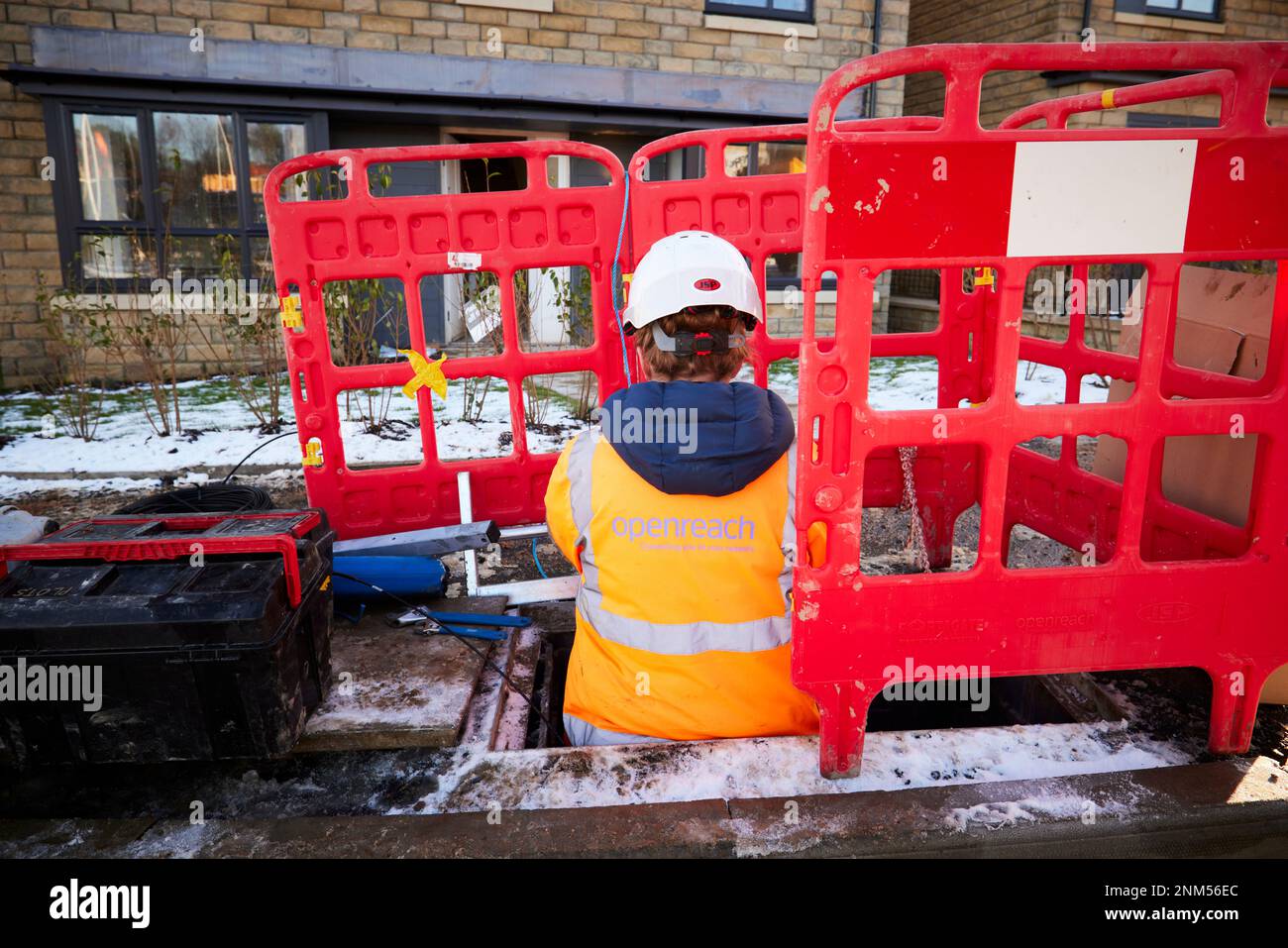 Female BT Openreach worker installing broadband fibre cables Stock ...