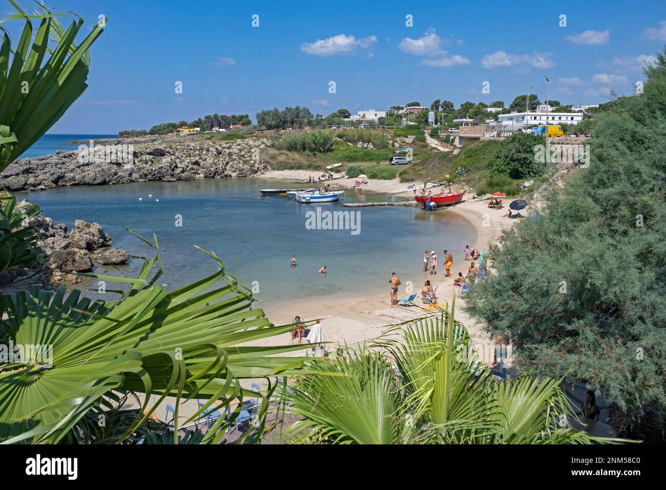 Italian tourists swimming and sunbathing on sandy beach in summer along ...